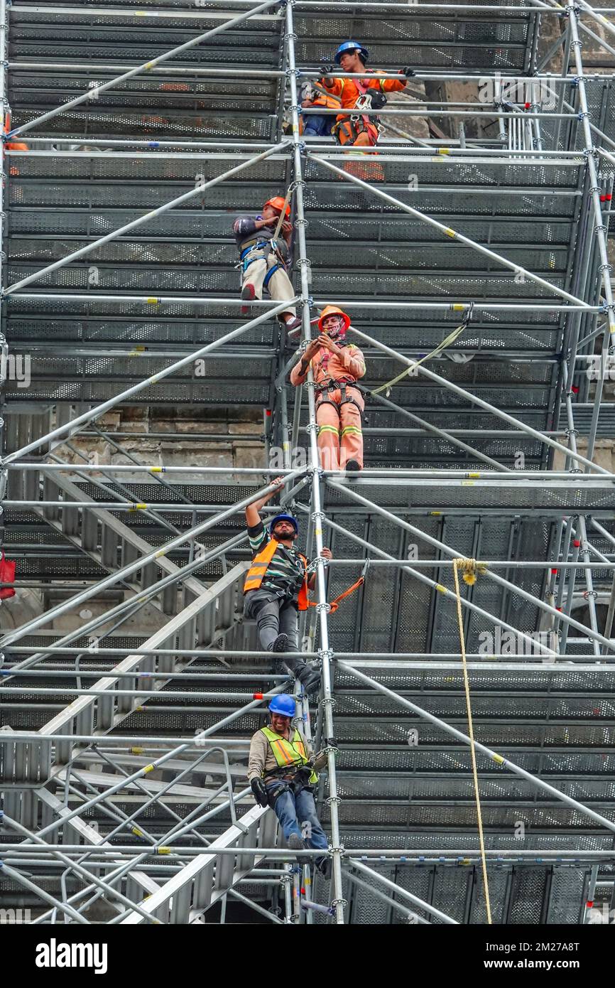 Construction workers assembly scaffolding around the Mexico City ...