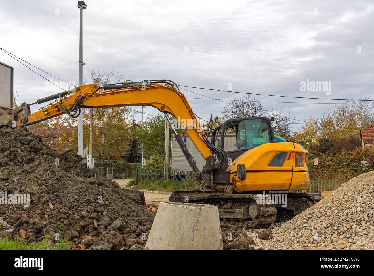 Excavator Digging Earth for Utility Sewer Pipes Construction Site Stock ...