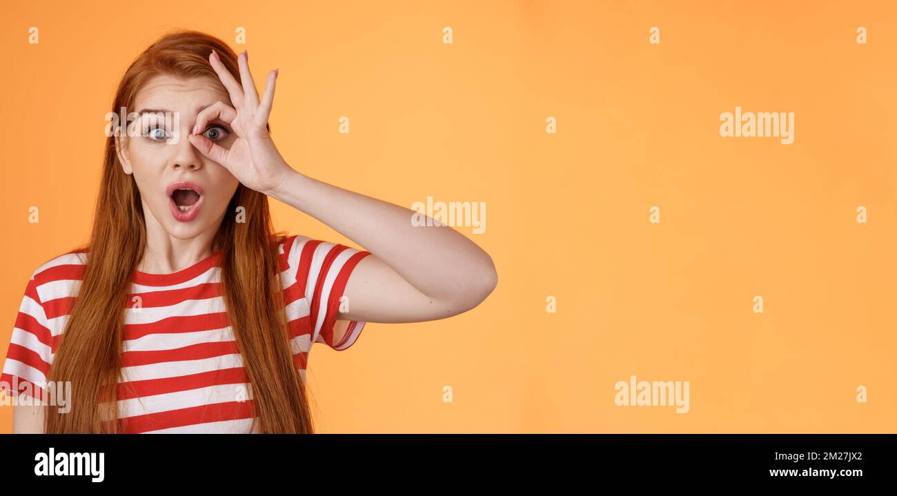 Surprised excited shocked young redhead girl gasping impressed look ...