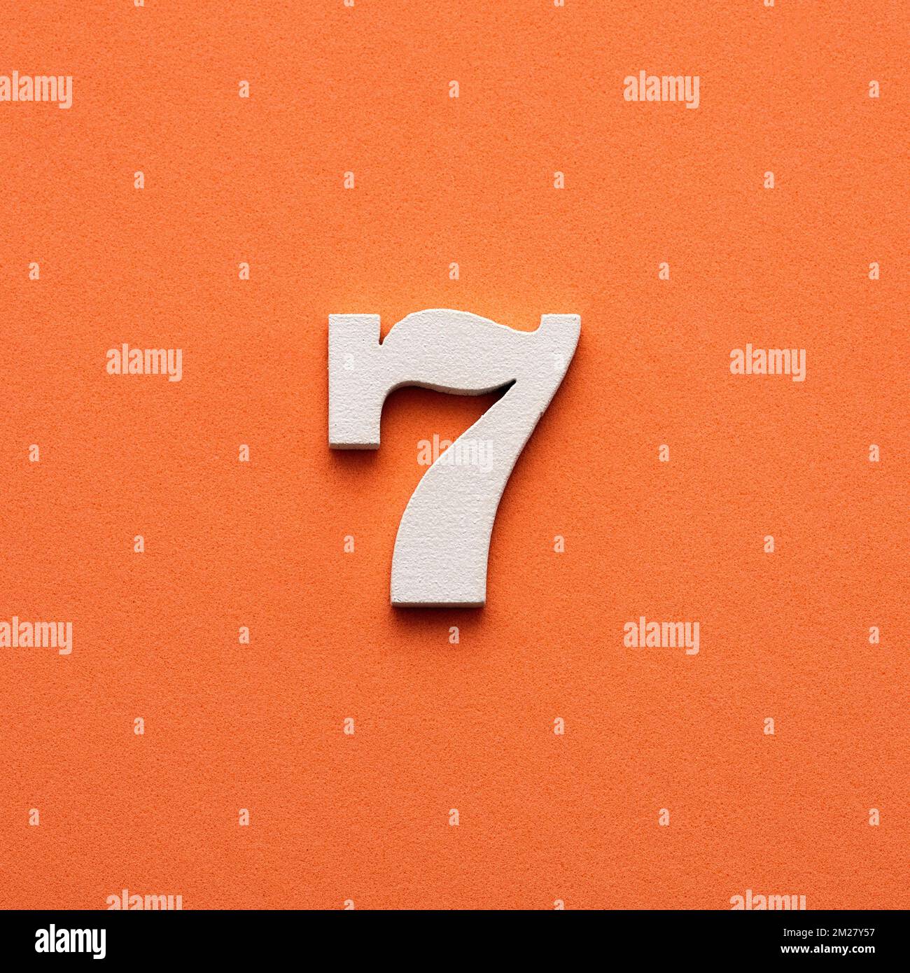 Number 7 - White wooden number on pink background Stock Photo - Alamy