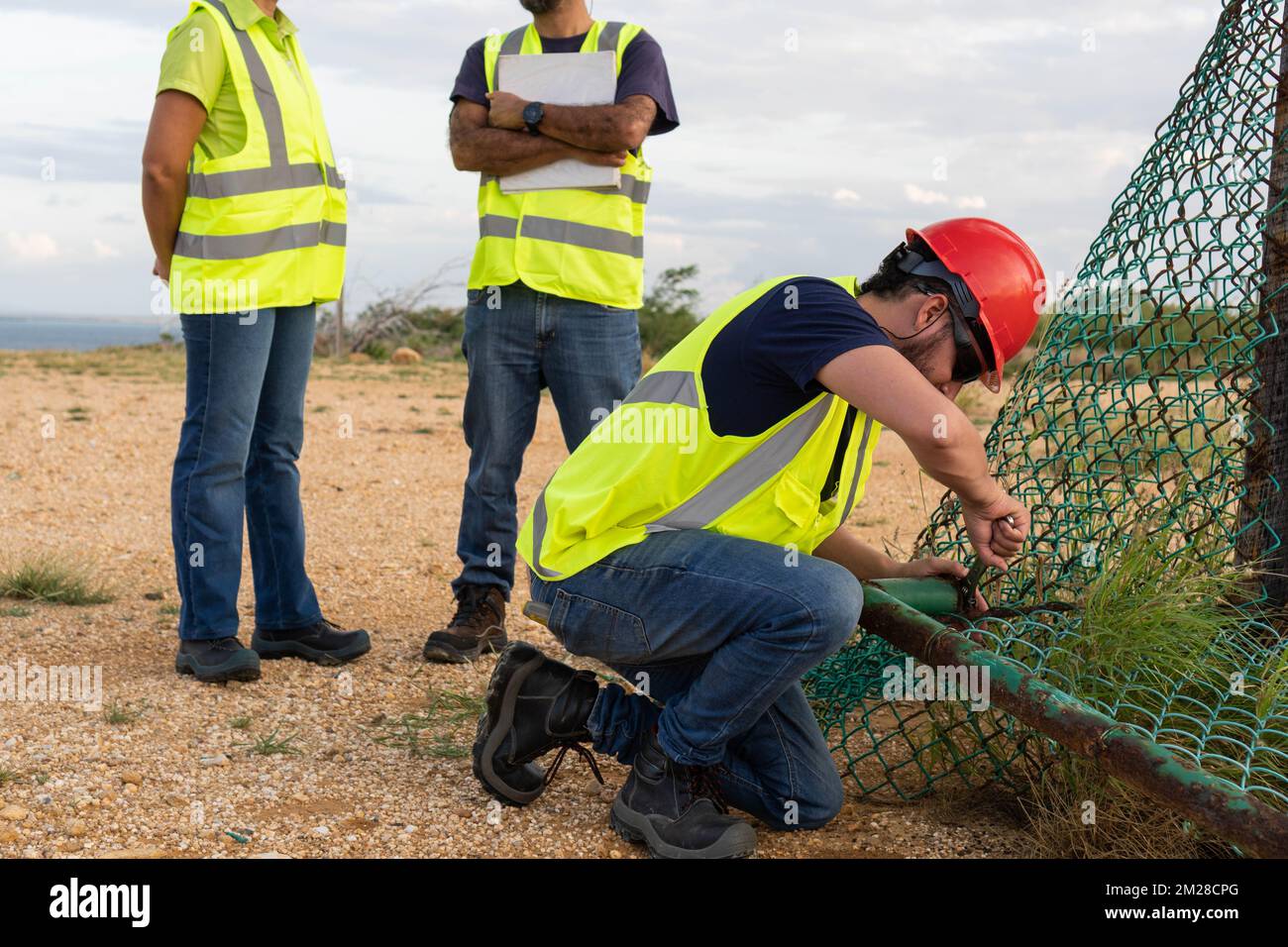 Three industrial workers working at a construction site Stock Photo - Alamy