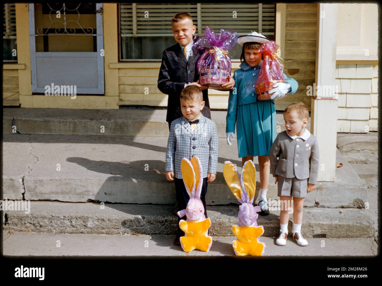 Children standing on steps with Easter baskets and decorations ...