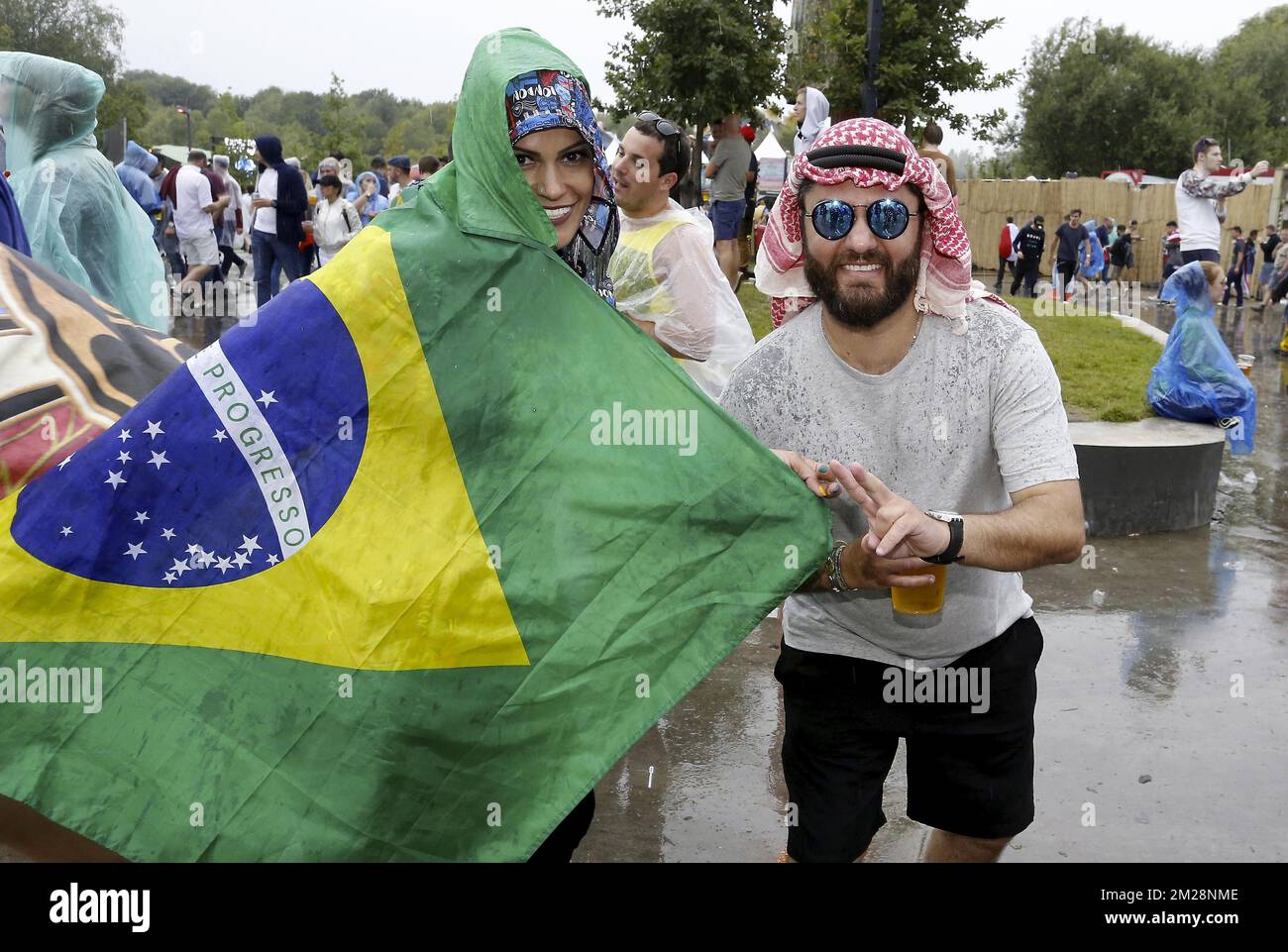 Illustration picture shows Brazilian festival visitors in the rain ...