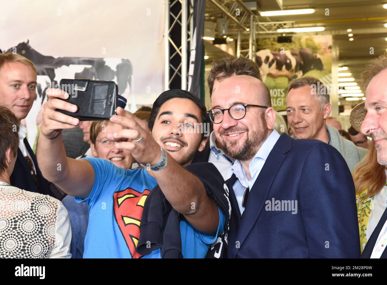 Belgian Prime Minister Charles Michel poses for a selfie with a visitor at a visit to the ...