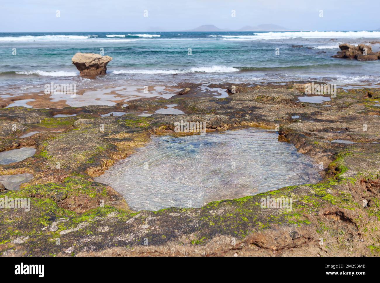 Natural pool of water on the coast . Standing water at the ocean shore ...