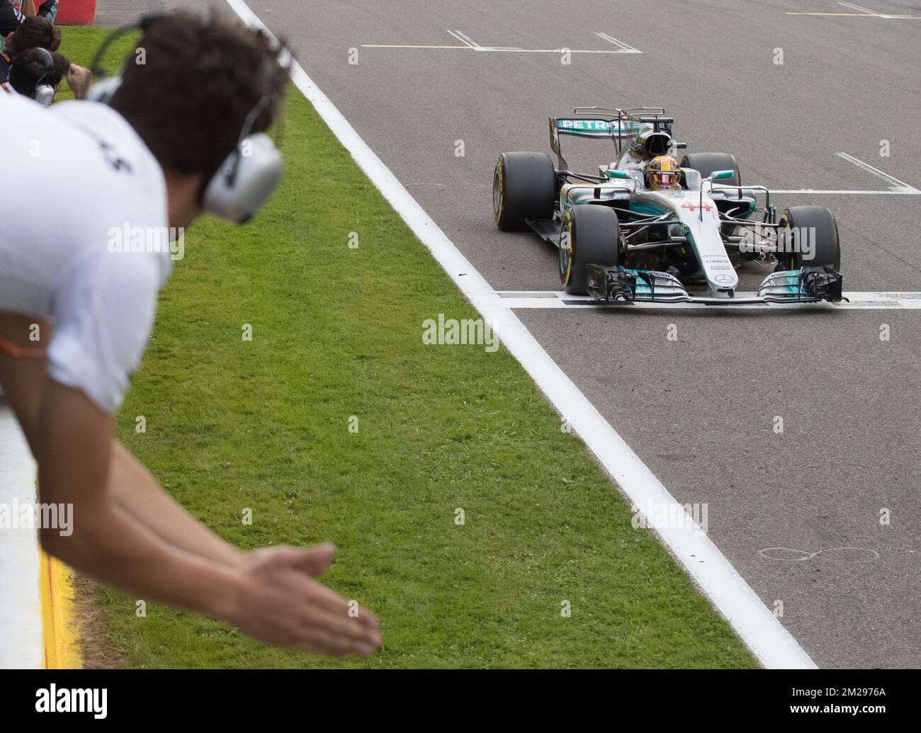 Mercedes' British driver Lewis Hamilton crosses the finish line at the ...