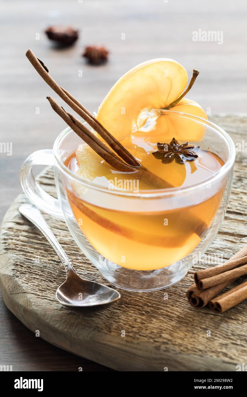 Hot apple cider and garnished with a cinnamon stick, apple slice and ...