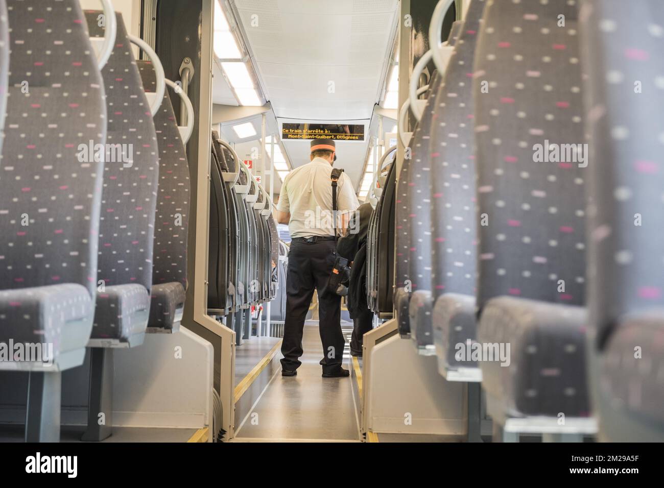 Train attendant looking for the last passenger before closing the doors ...