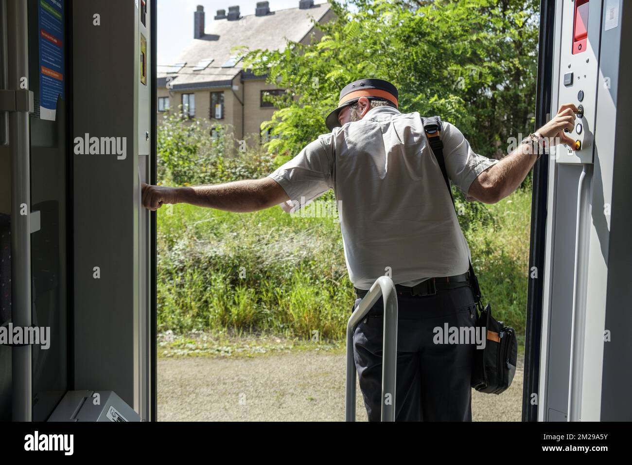 Train attendant looking for the last passenger before closing the doors ...