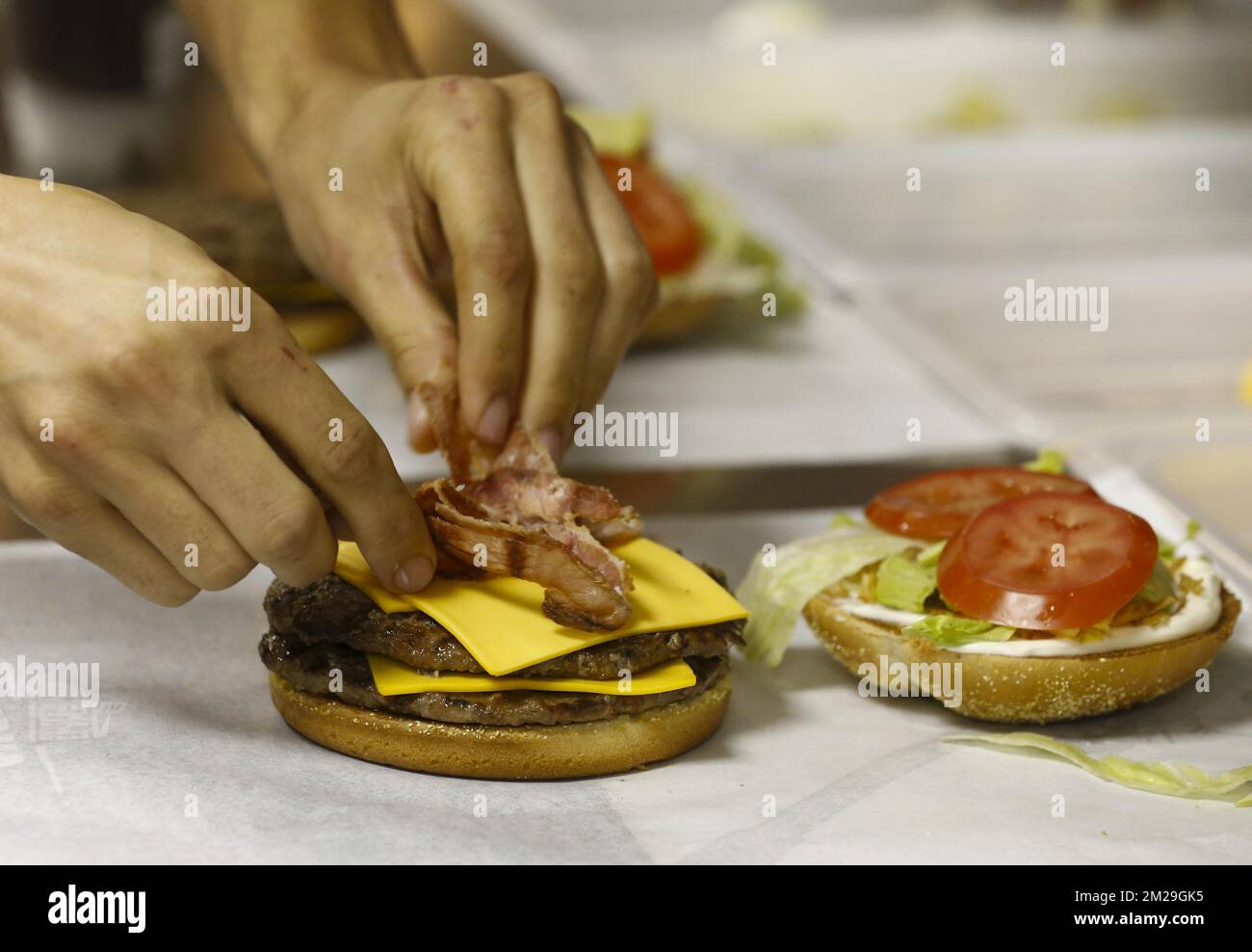 Illustration picture shows employee preparing a burger during the ...
