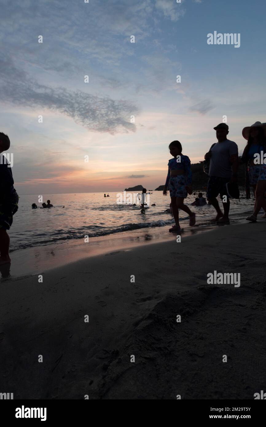 Beautiful sunset scene of Rodadero beach sunset with tourist walking ...