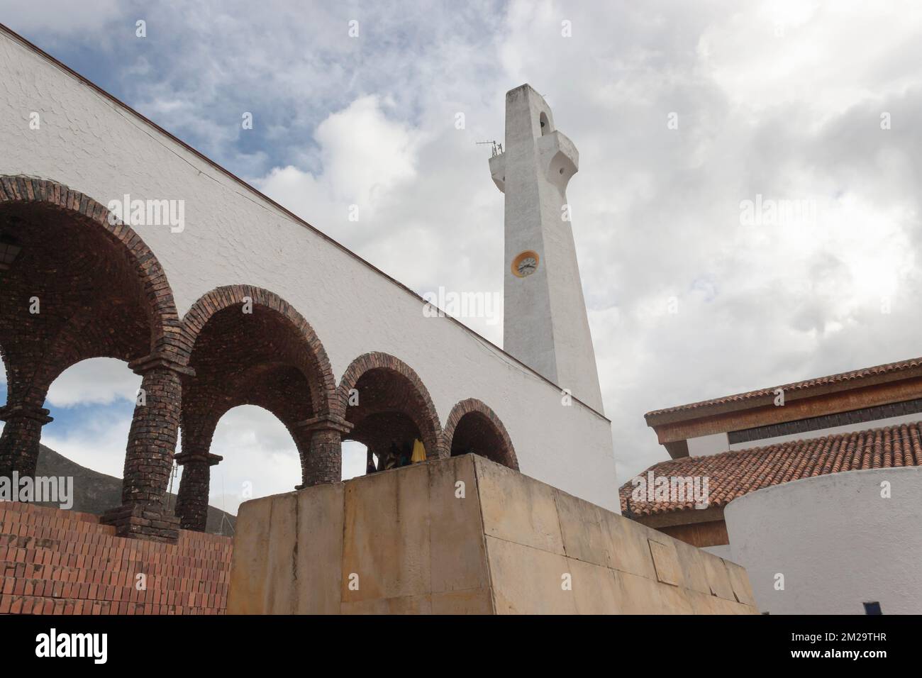 Ground view of colombian guatavita town clock tower with brick arc ...