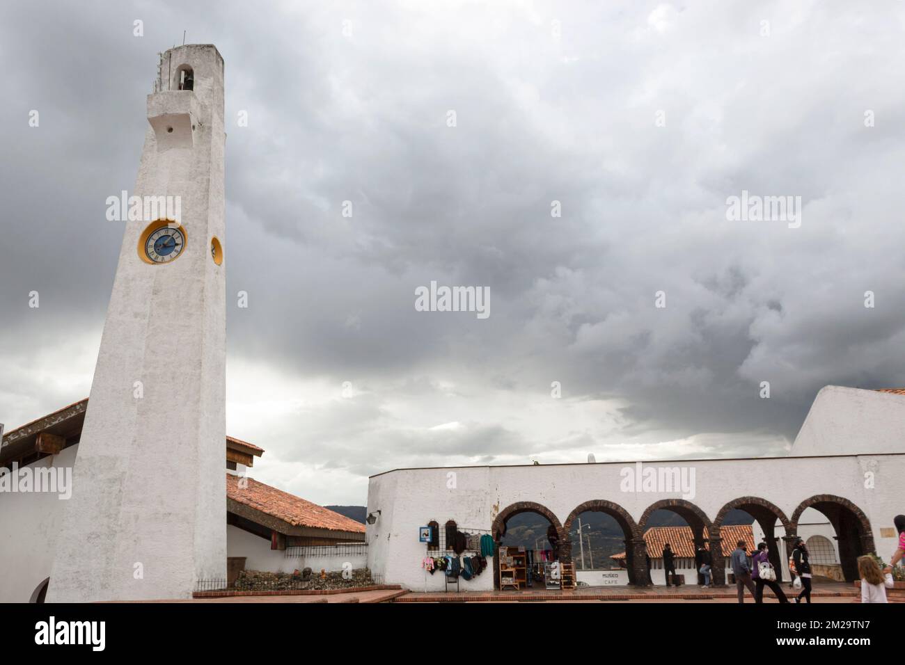 White clock tower with colonial arc structure at Guatavita colombian ...