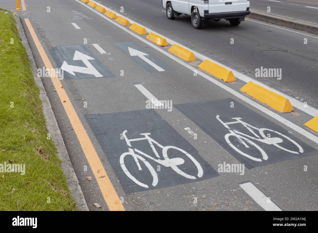 Closeup to a bike path symbols near to a street in sunny day Stock ...