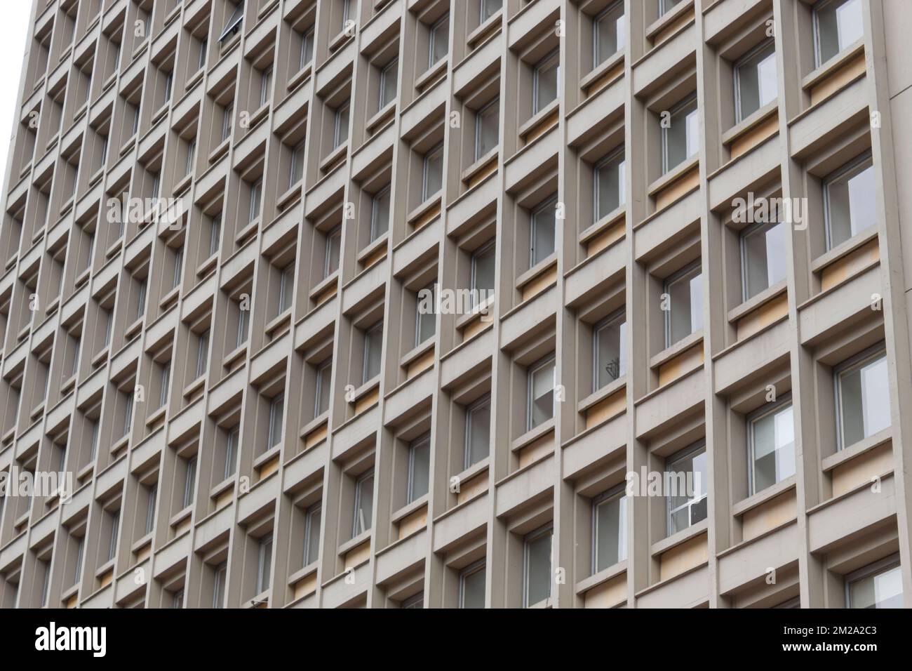 Windows and square patterns of an old skyscraper. Architecture details ...
