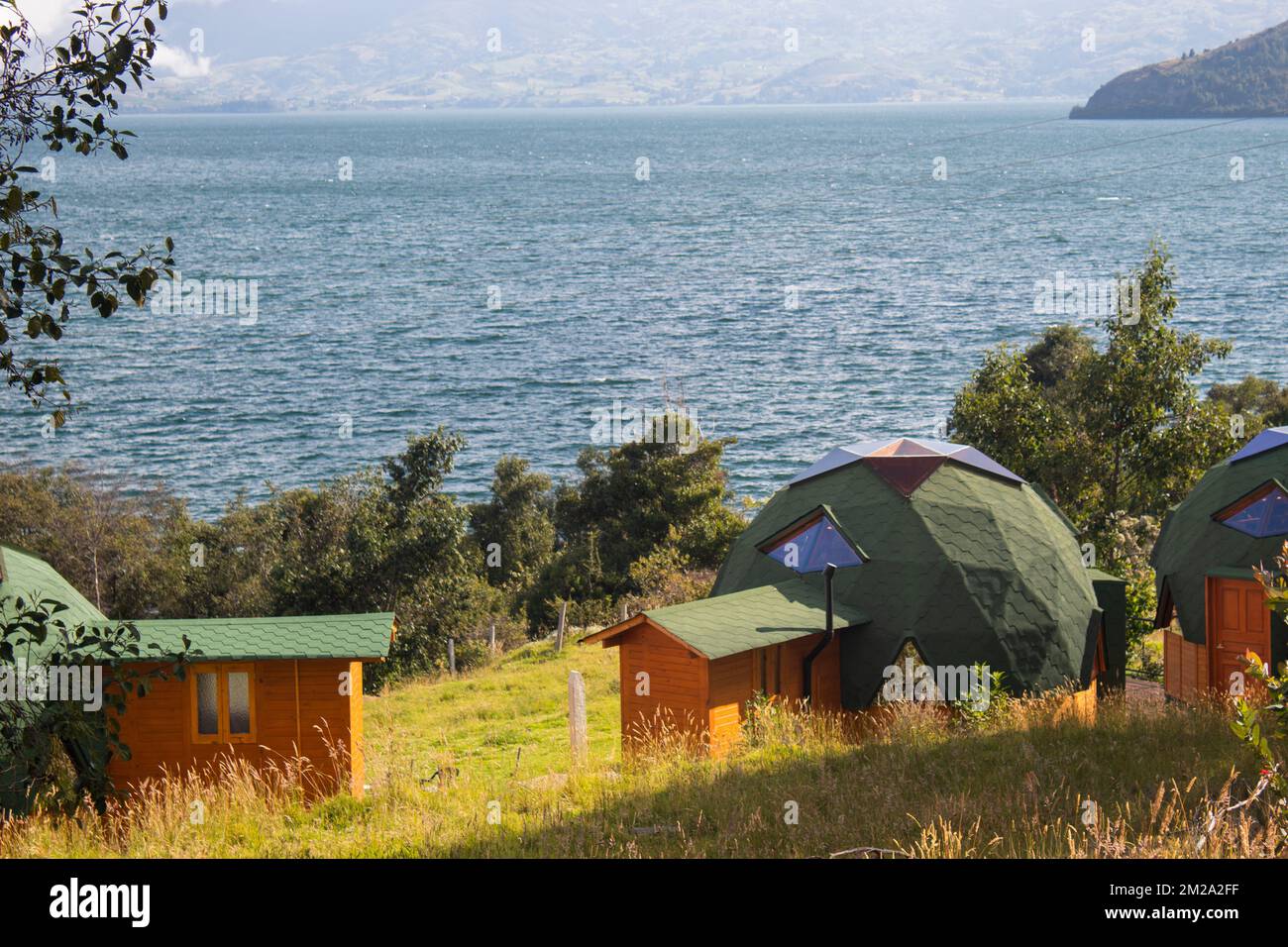 Beautiful wooden glamping viewpoint landscape with blue lake and ...