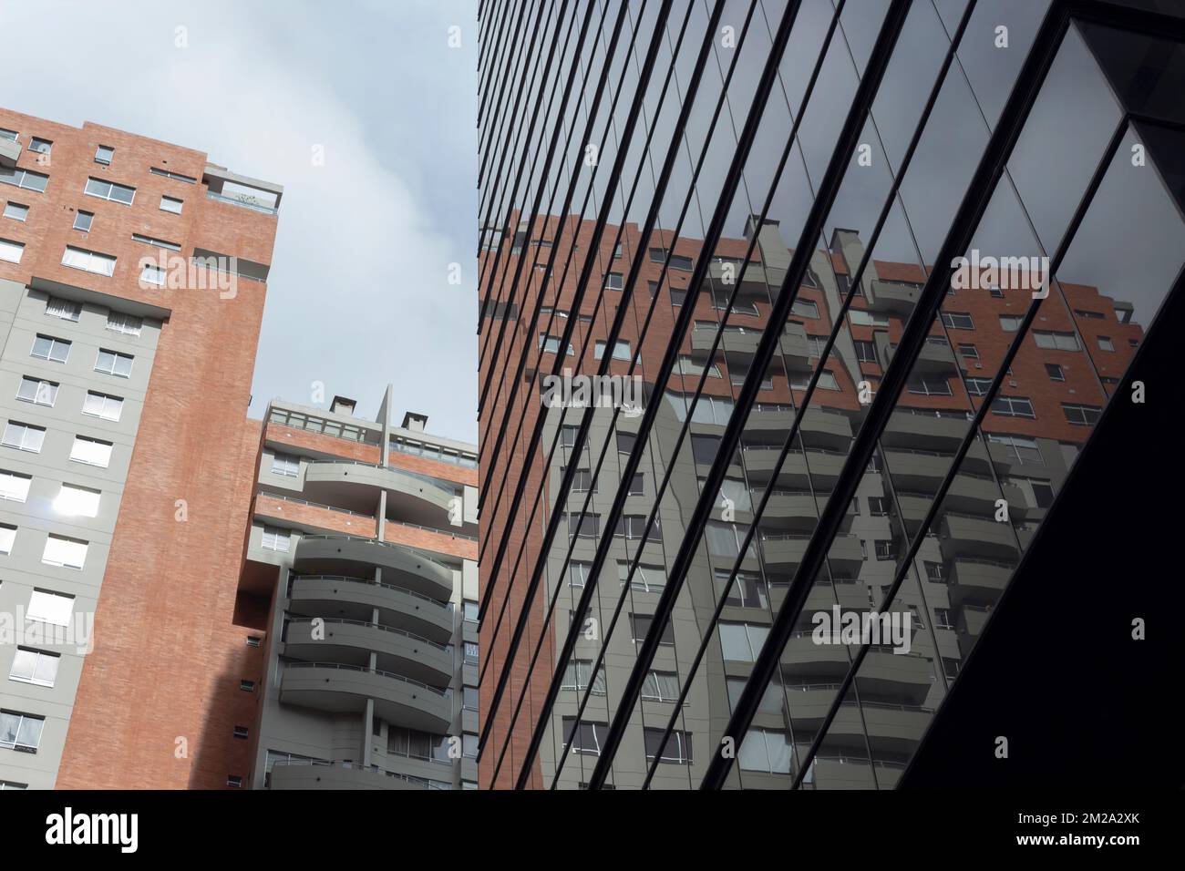 BOGOTA, COLOMBIA - Low angle view of an old brick building reflected in ...