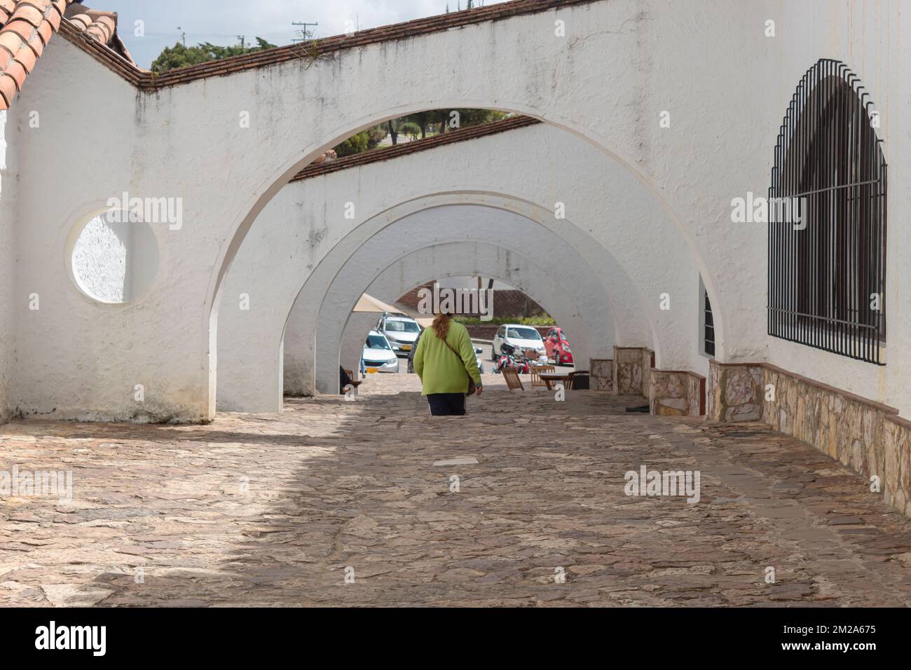 Closeup to a female tourist walking across arc street in middle of ...