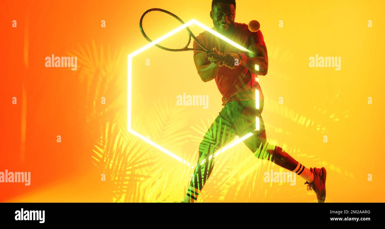 Smiling african american tennis player with racket and ball by ...