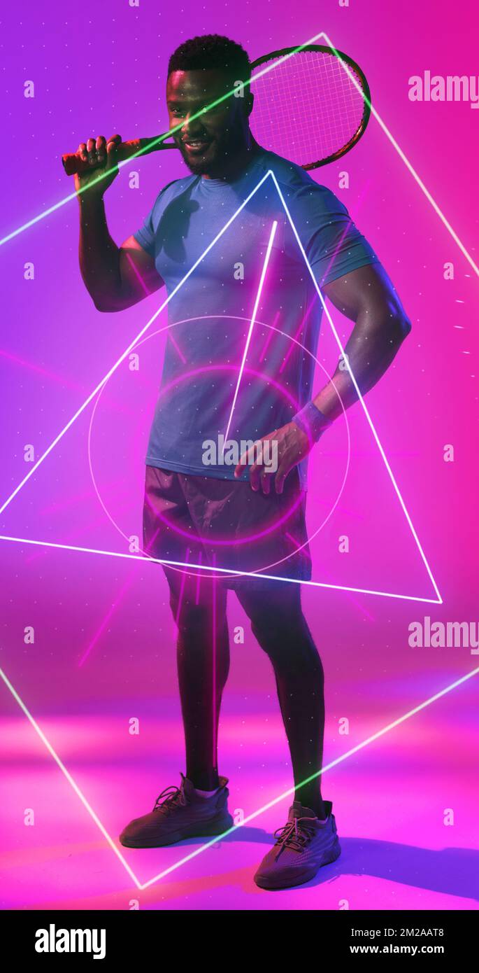 African american male tennis player holding racket over illuminated ...