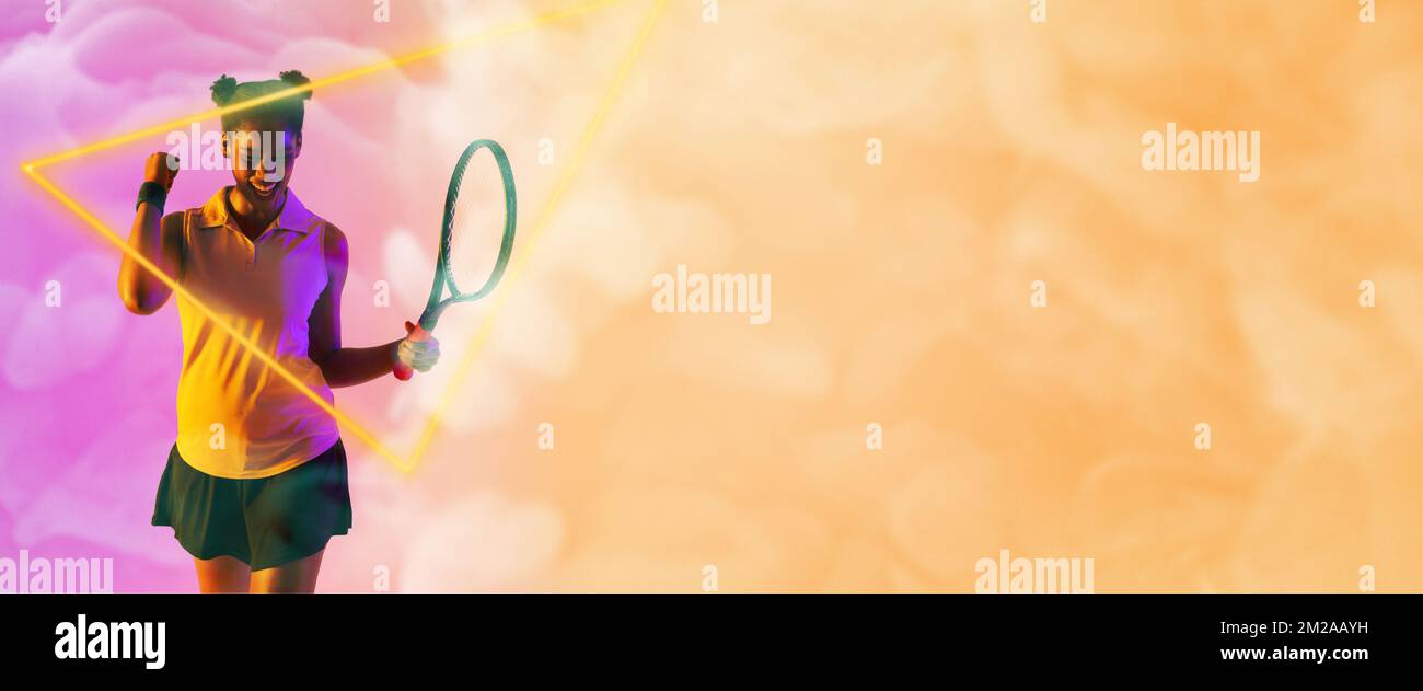 African american female tennis player holding racket and shaking fist ...