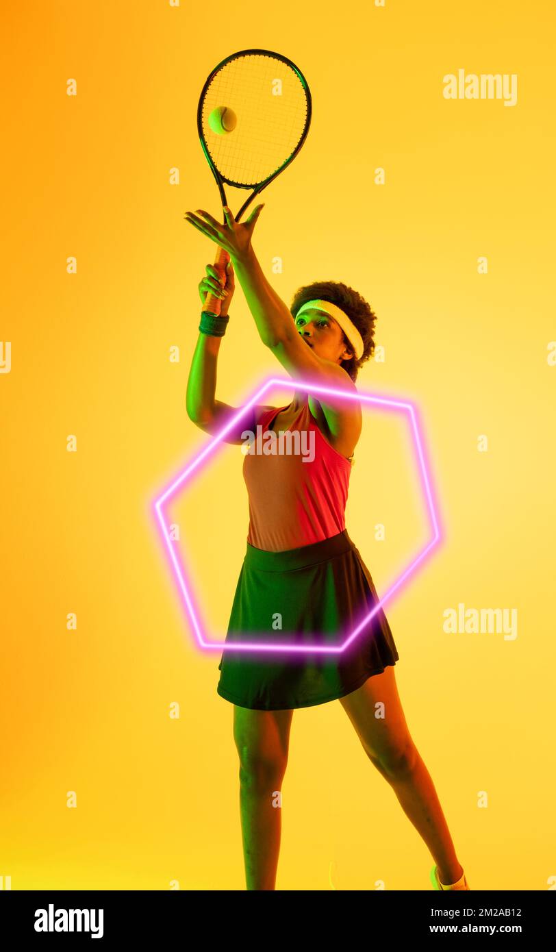 African american female tennis player hitting ball with racket by ...