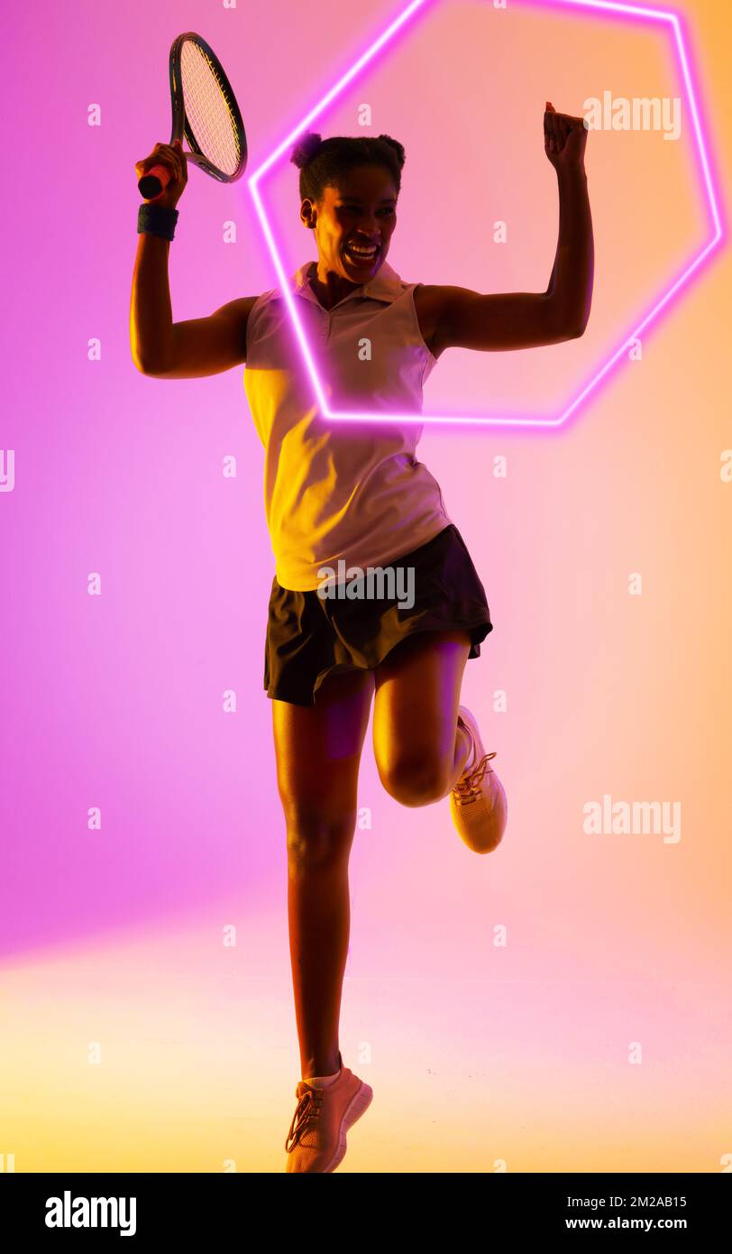 Excited african american tennis player holding racket and raising hands ...