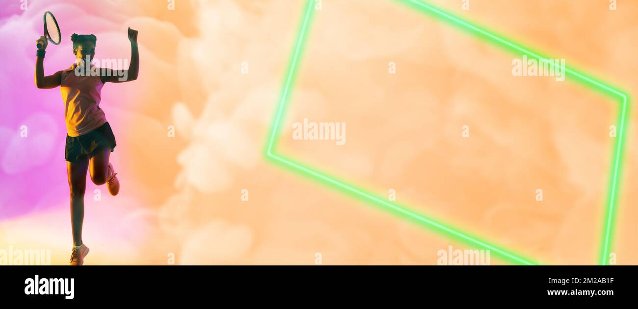 Excited african american female tennis holding racket and jumping by ...