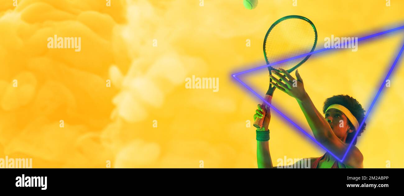 African american female player hitting ball with racket by illuminated ...