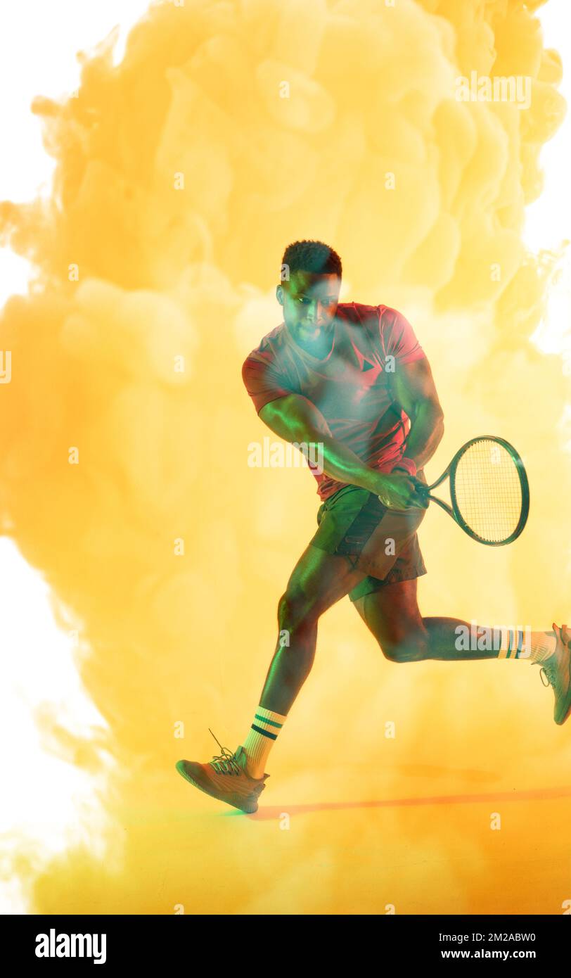 African american male tennis player running and hitting with racket ...
