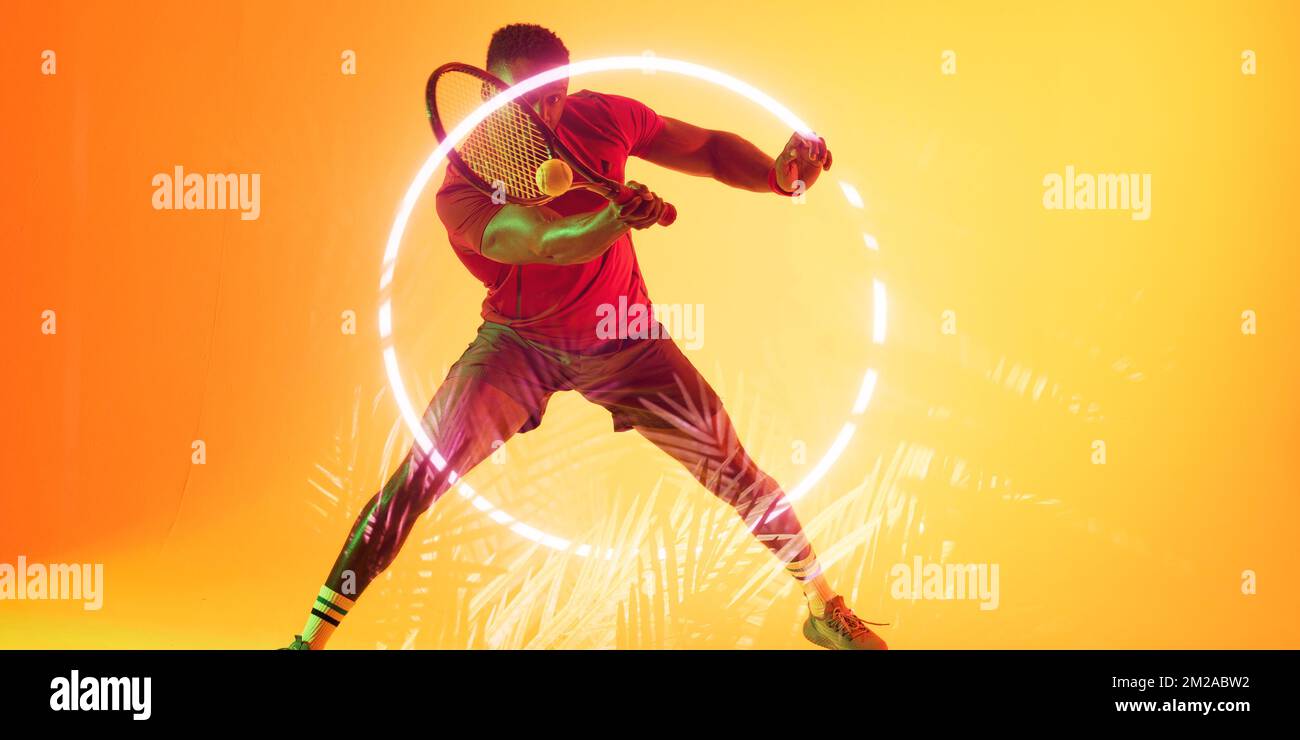 Illuminated circle and plants over african american male tennis player ...