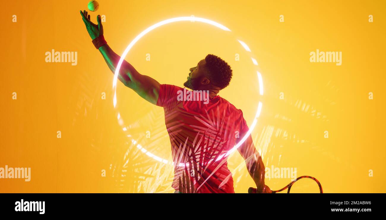 Illuminated circle and plants over african american male tennis player ...
