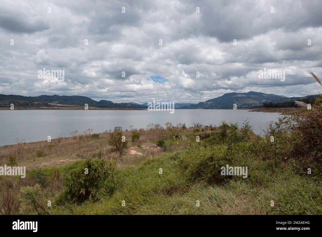 Tomine Guatavita colombian lake landscape with mountains and cloudy sky ...