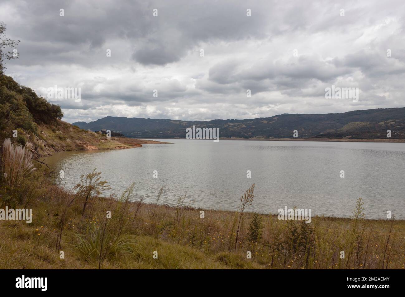 Guatavita tomine lake reflection with grey and white sky landscape ...
