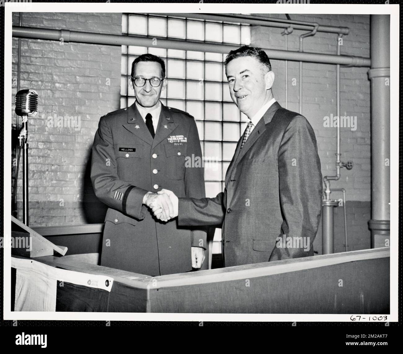 Col. Kellogg shaking hands with man , Armories, Ordnance industry ...