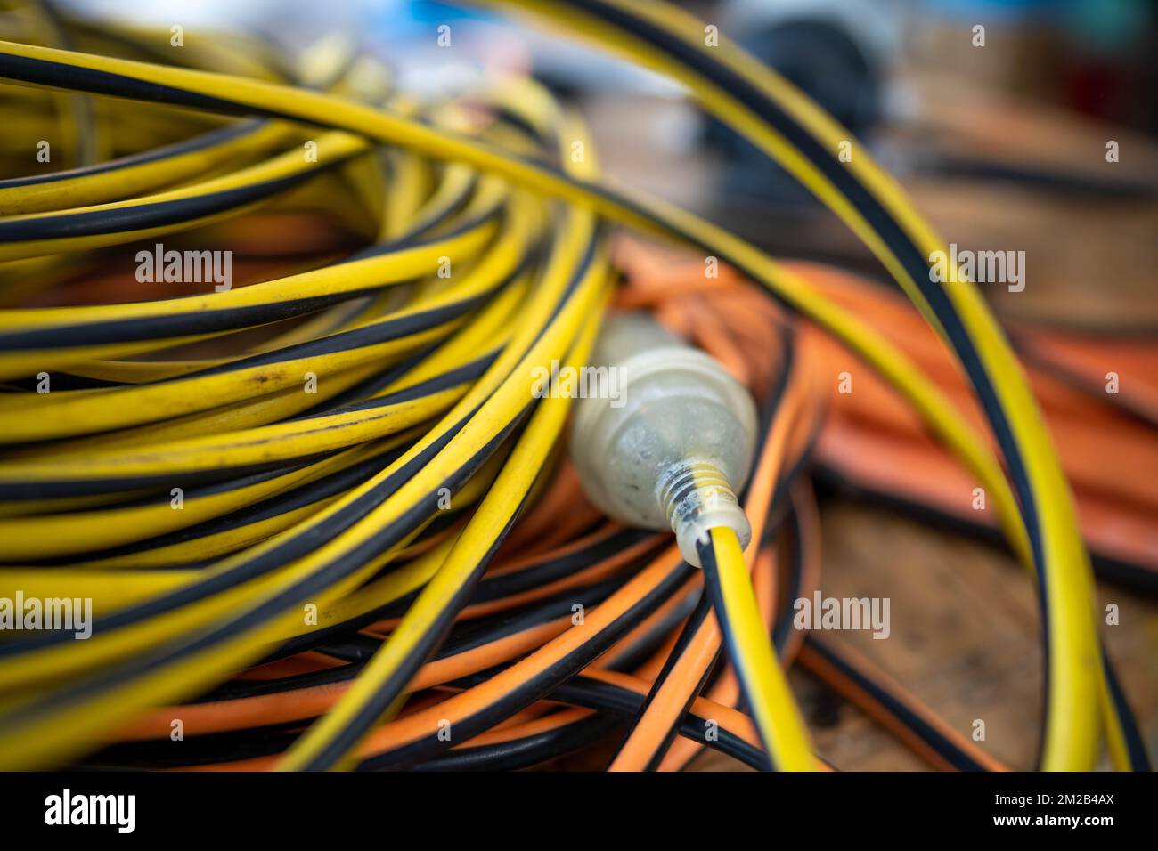 extension cord wrapped up on the ground. extension lead, power lead on ...