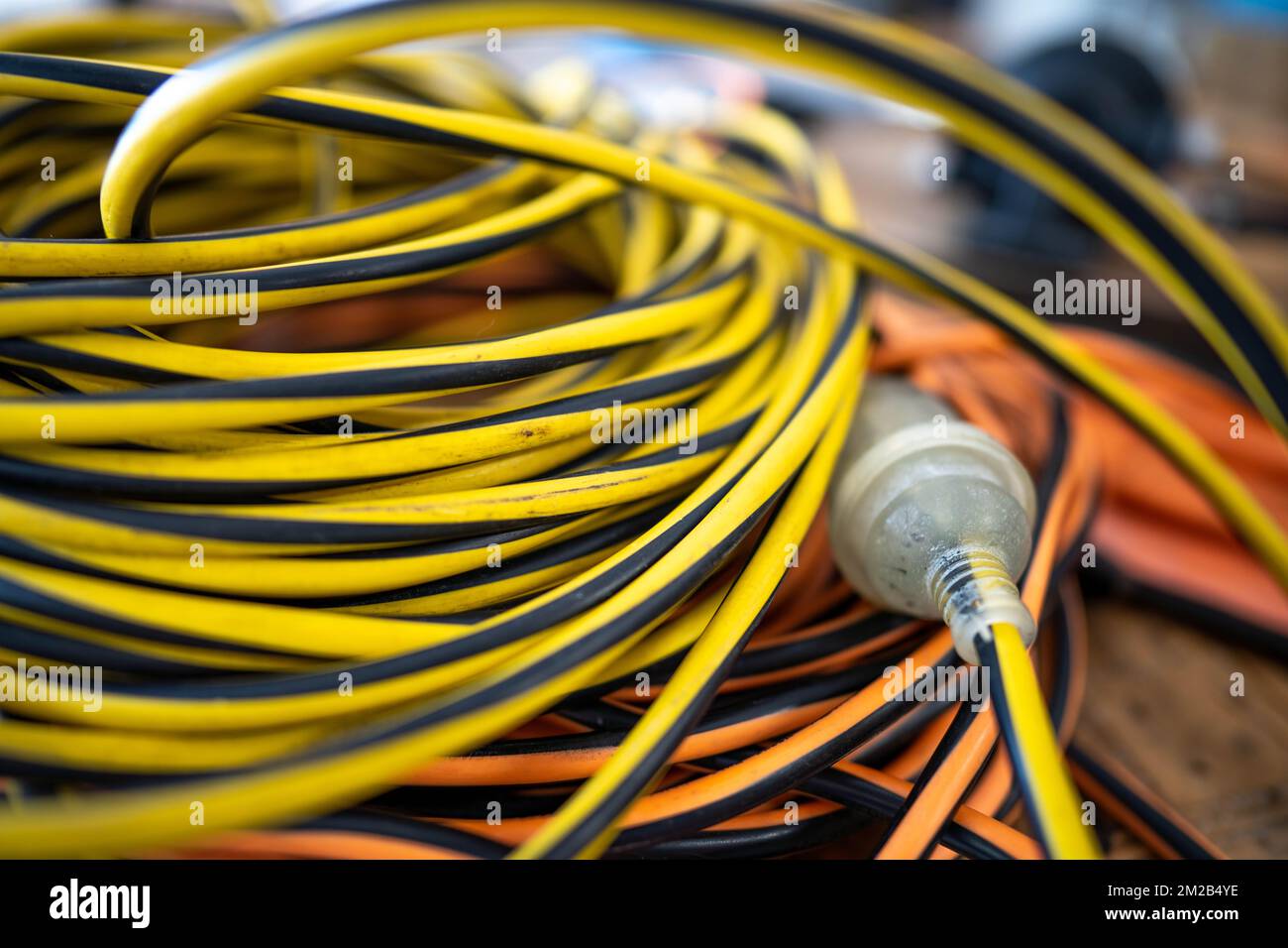 extension cord wrapped up on the ground. extension lead, power lead on ...