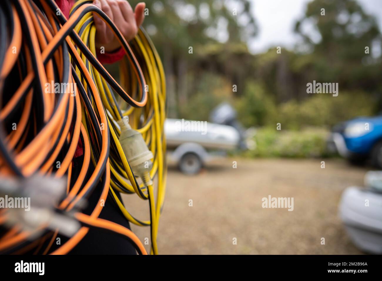 power lead on a building site, electrician with a power cable outside ...