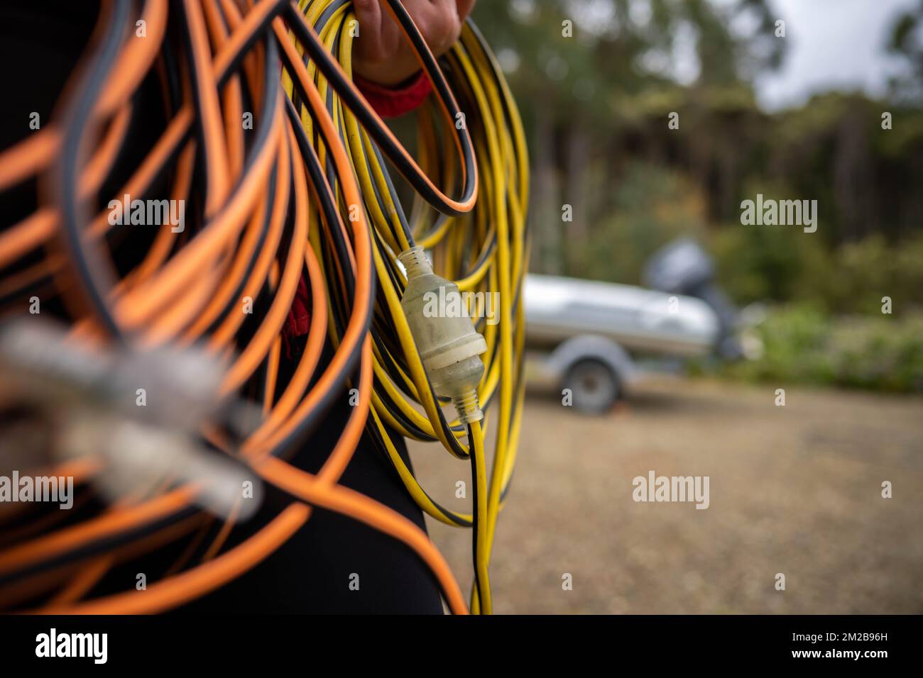 extension cord wrapped up on the ground. extension lead, power lead on ...