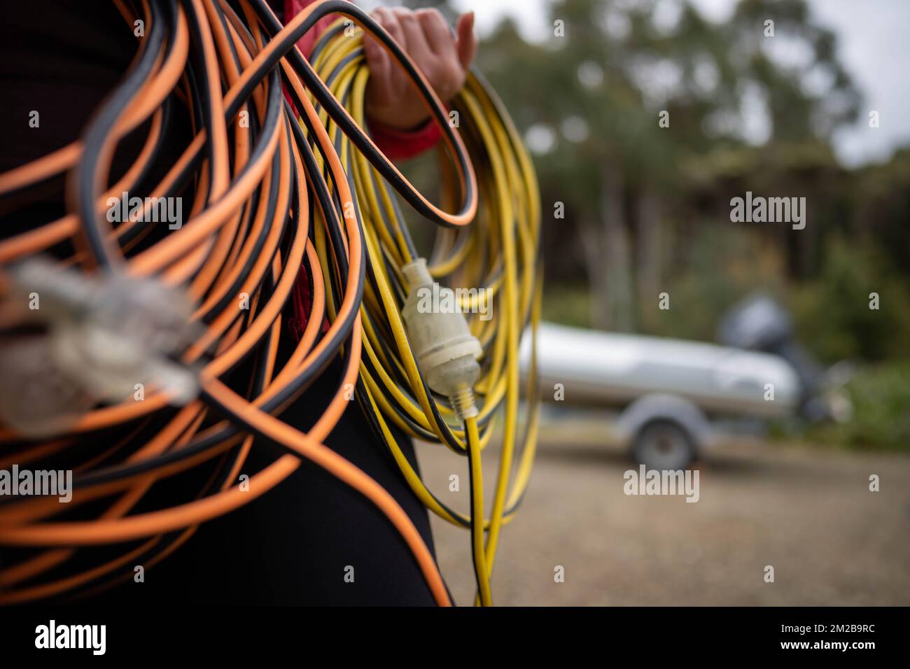 power lead on a building site, electrician with a power cable outside ...