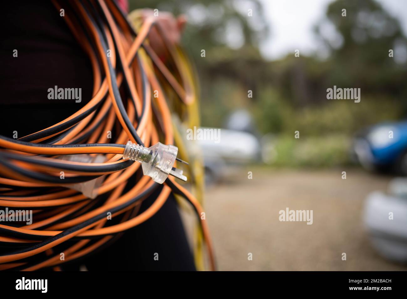 extension cord wrapped up on the ground. extension lead, power lead on ...