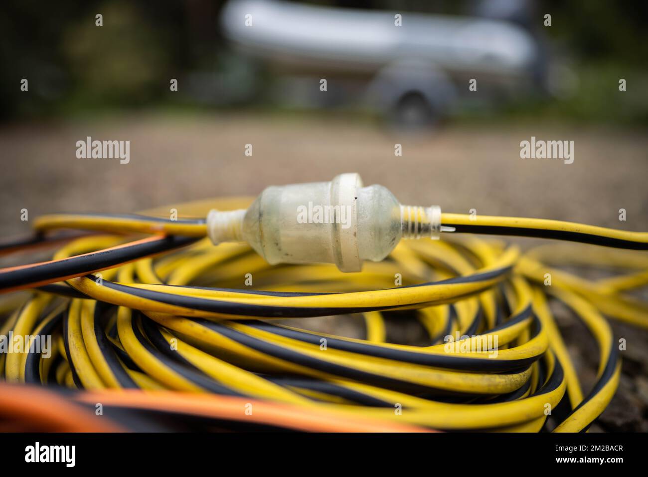 power lead on a building site, electrician with a power cable outside ...