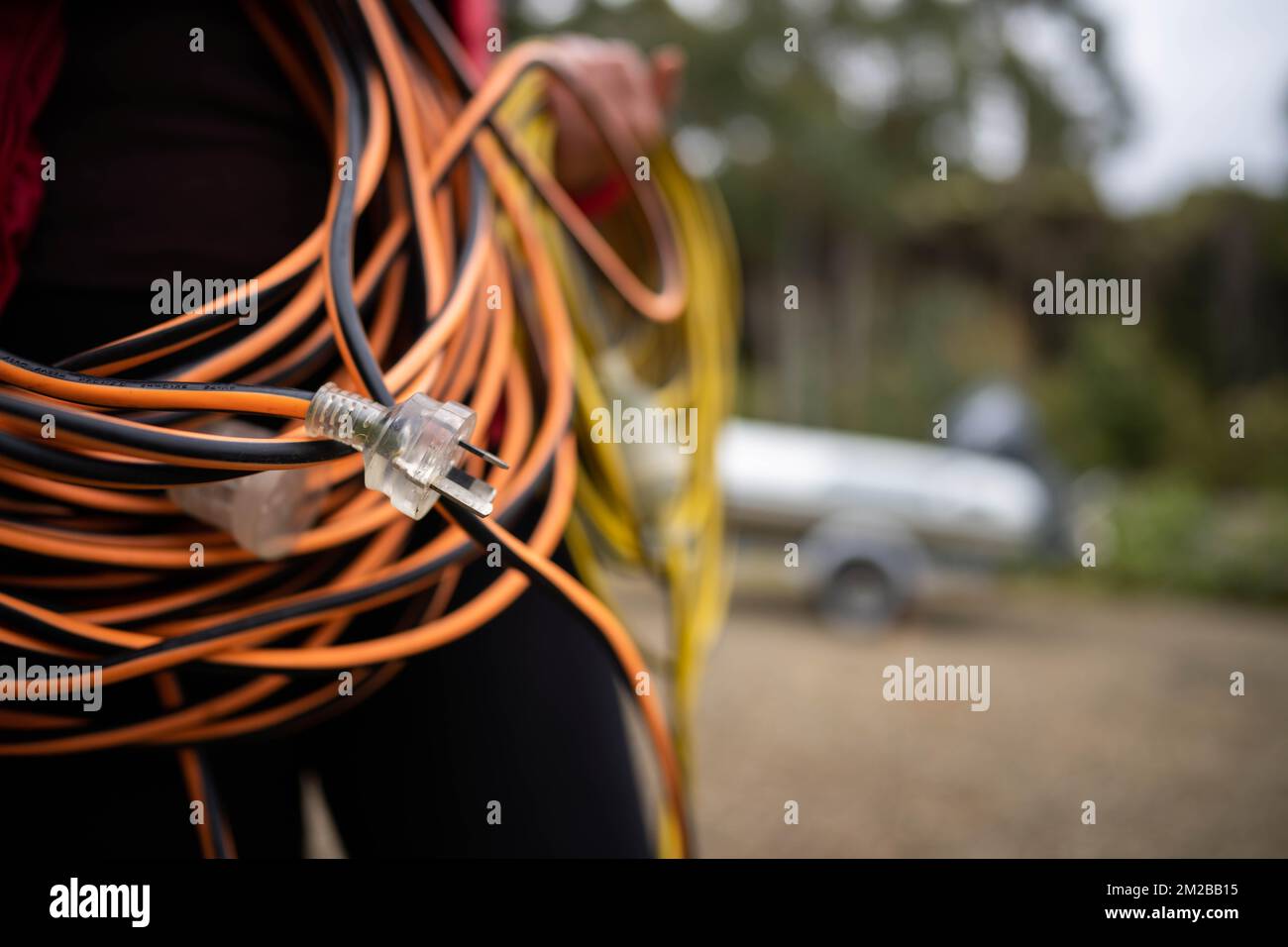 power lead on a building site, electrician with a power cable outside ...