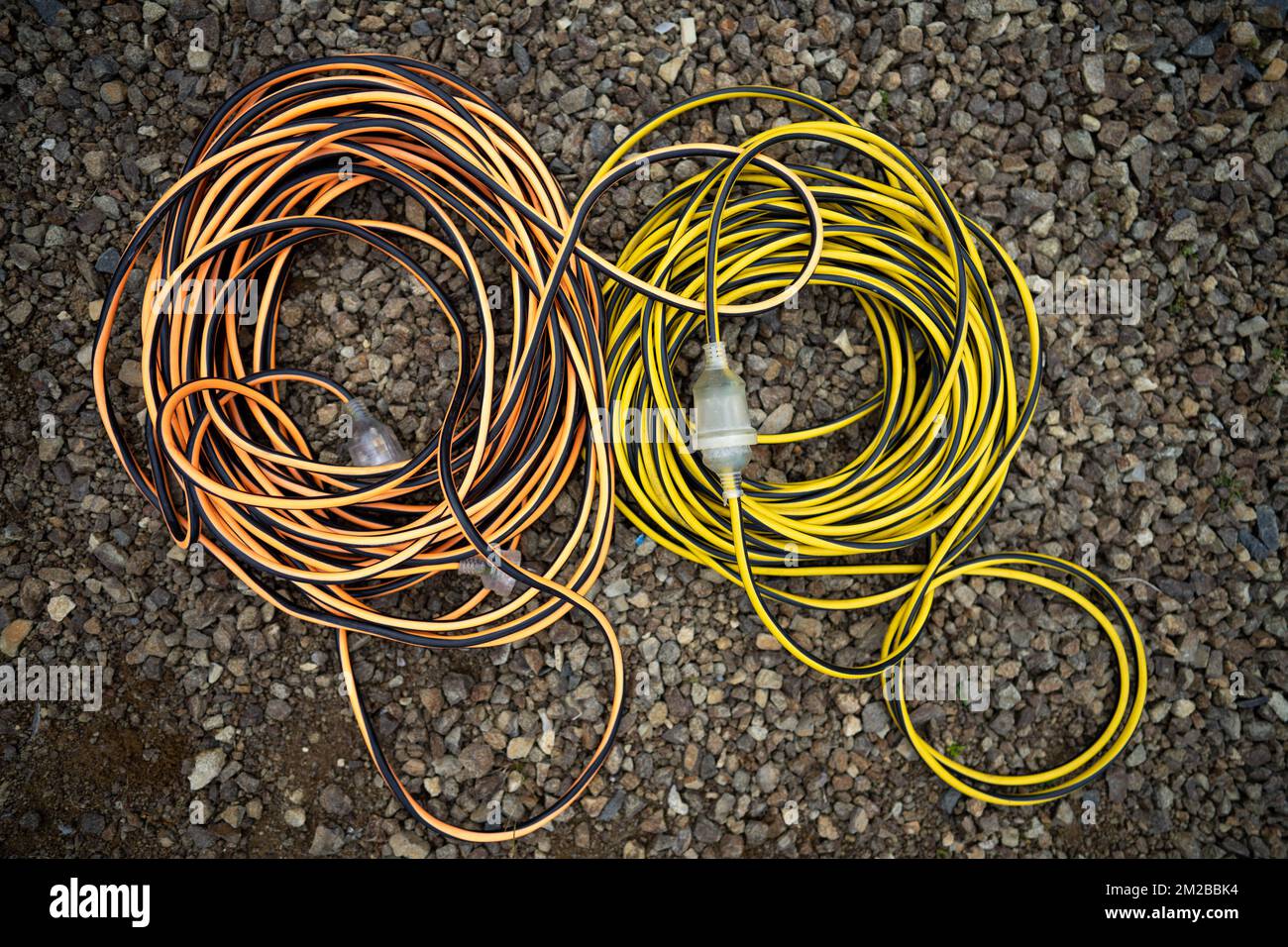 extension cord wrapped up on the ground. extension lead, power lead on ...