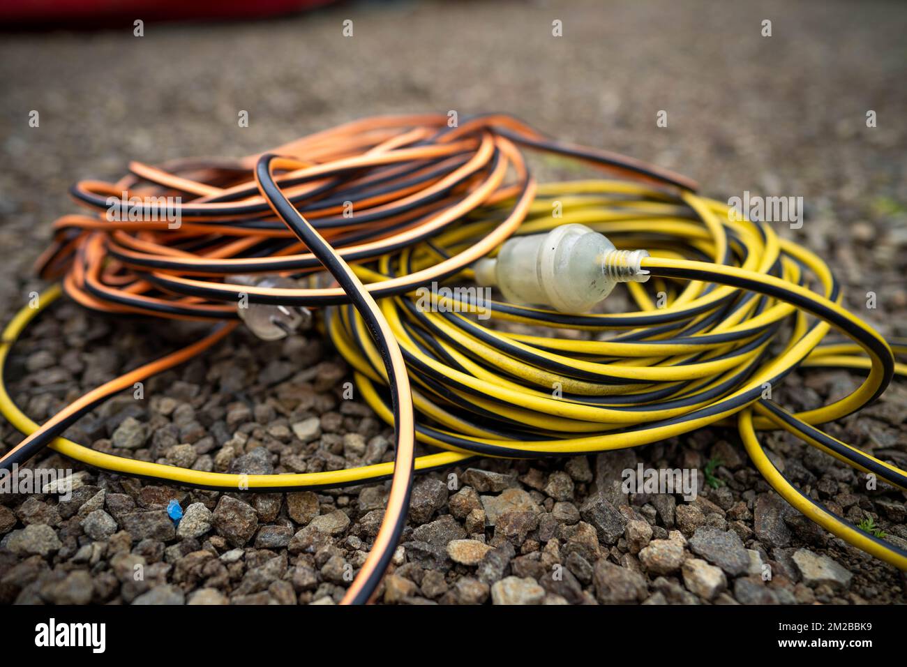 extension cord wrapped up on the ground. extension lead, power lead on ...