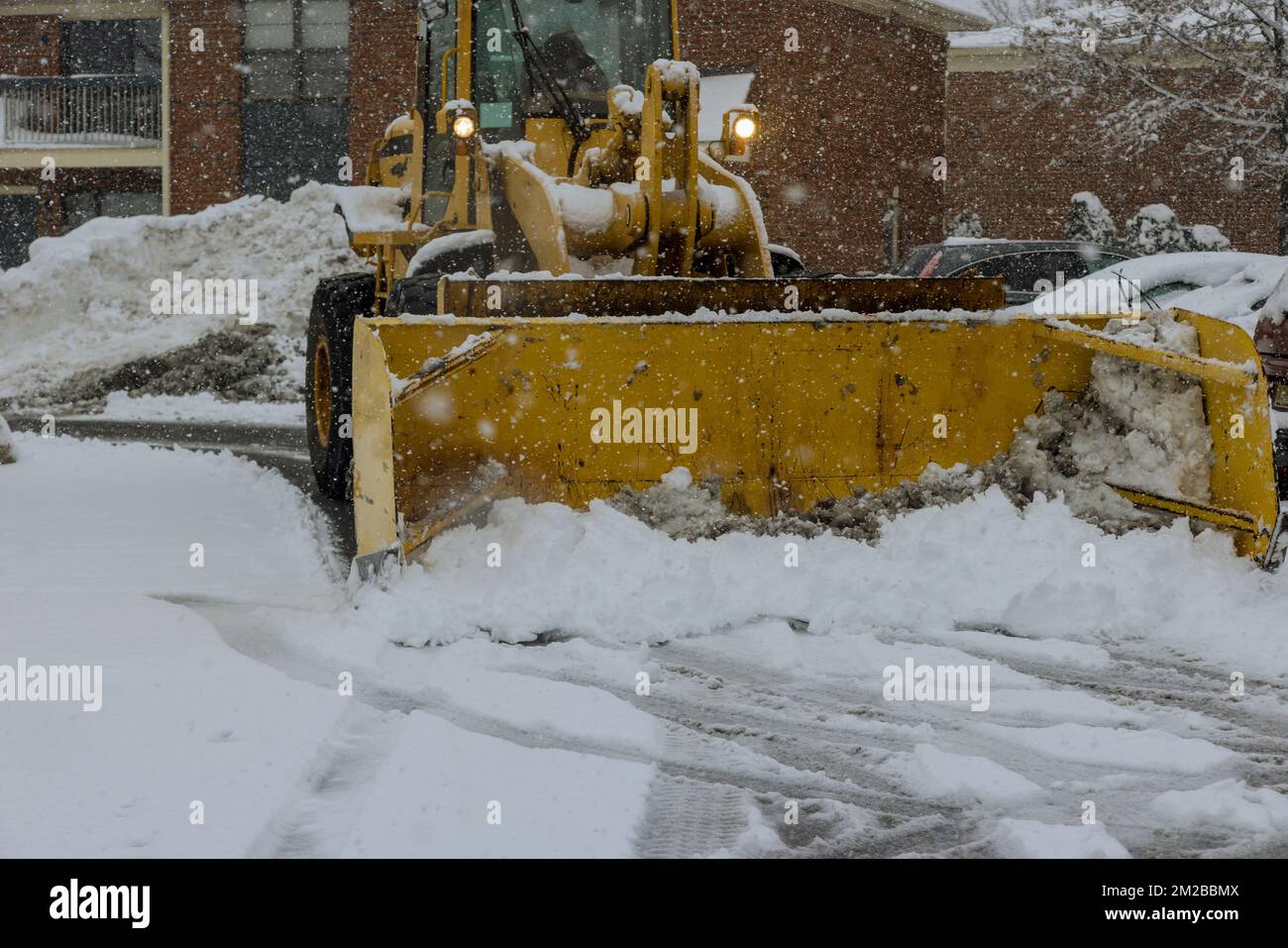 Snow blizzard clean up of snow with tractor after huge snowstorm in ...