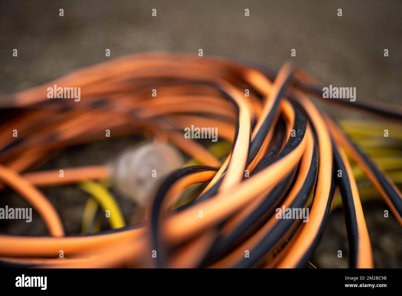power lead on a building site, electrician with a power cable outside ...