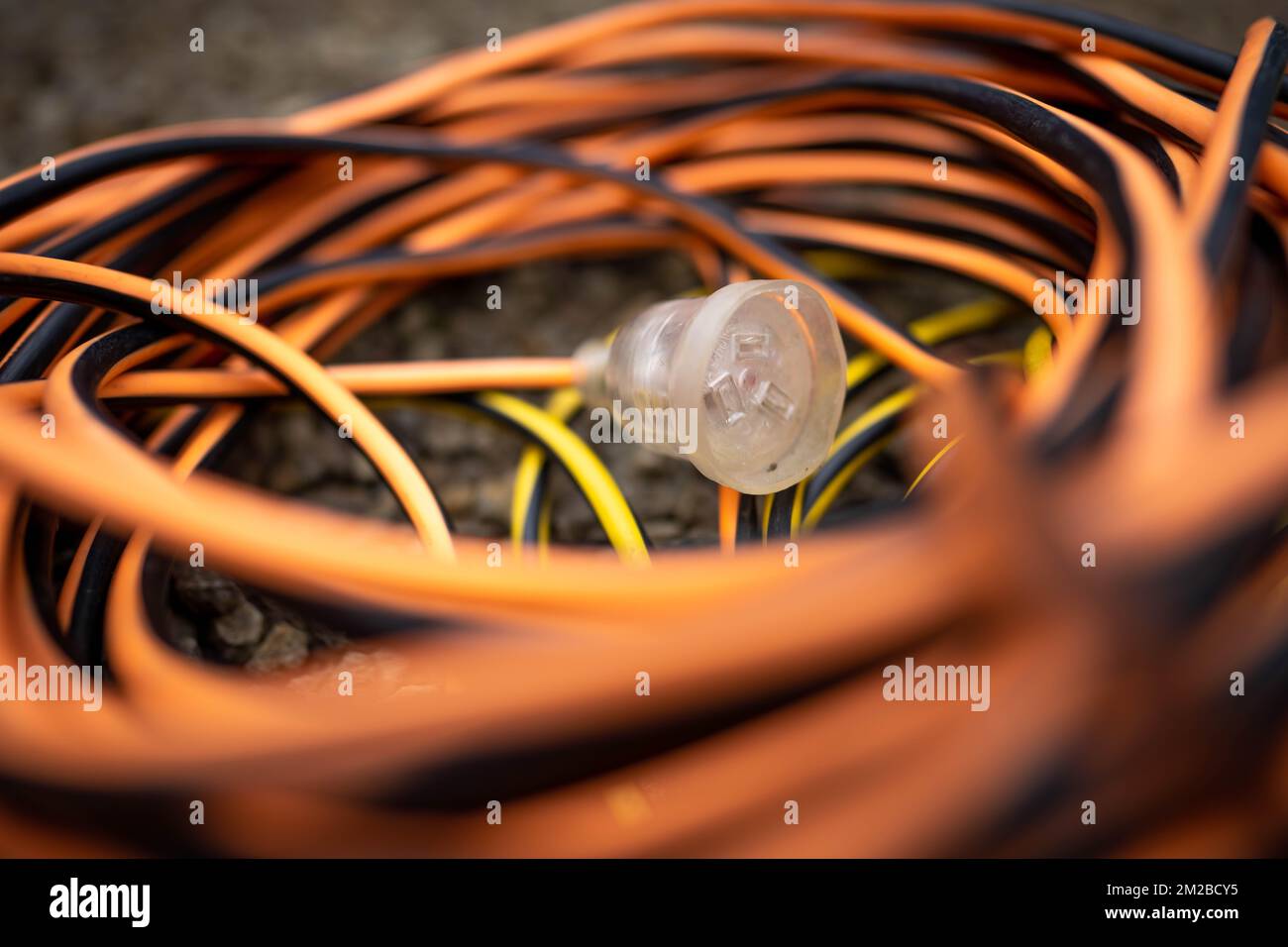 power lead on a building site, electrician with a power cable outside ...