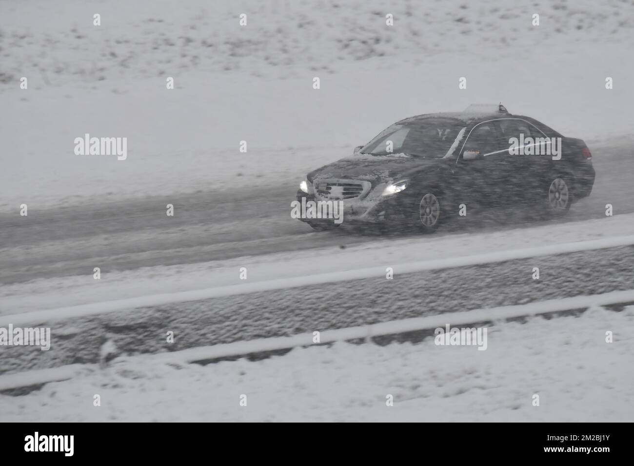 Illustration picture shows a snow-covered car on the E19 high way in ...