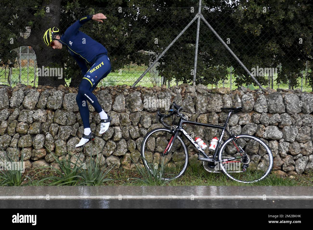 Belgian Jens Keukeleire of Orica Scott jumps over a stone wall during a ...
